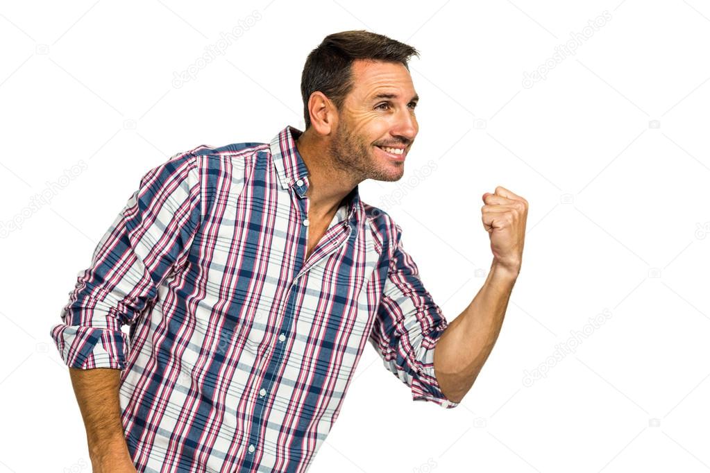Triumphant man raising fist Stock Photo by ©Wavebreakmedia 96511478 Triumphant man raising fist Stock Photo by ©Wavebreakmedia 96511478
