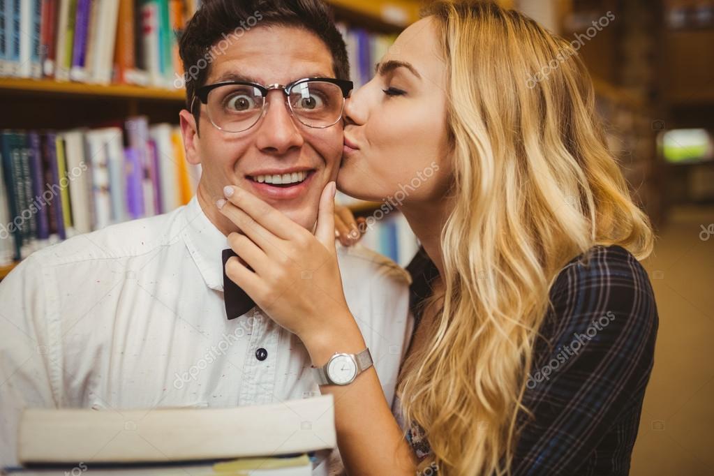 Nerd getting kissed by pretty girl Stock Photo by ©Wavebreakmedia 97059776