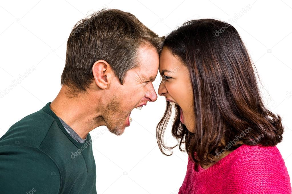 Couple yelling while standing head to head Stock Photo by ...