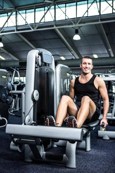 Man using exercise machine for legs - Stock Image - Everypixel