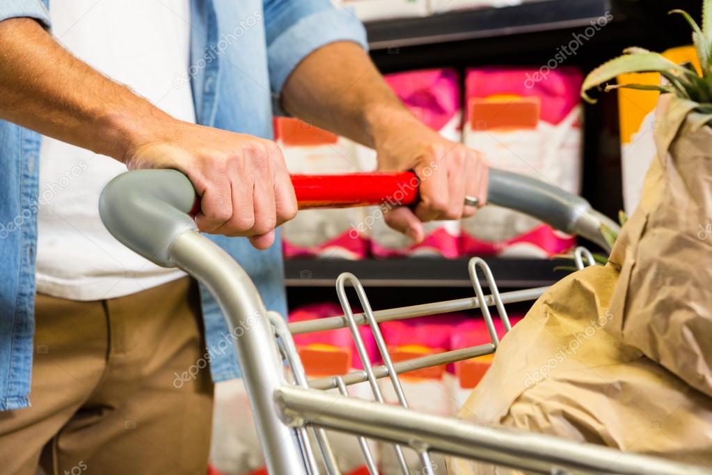 Man pushing trolley — Stock Photo © Wavebreakmedia #98050990