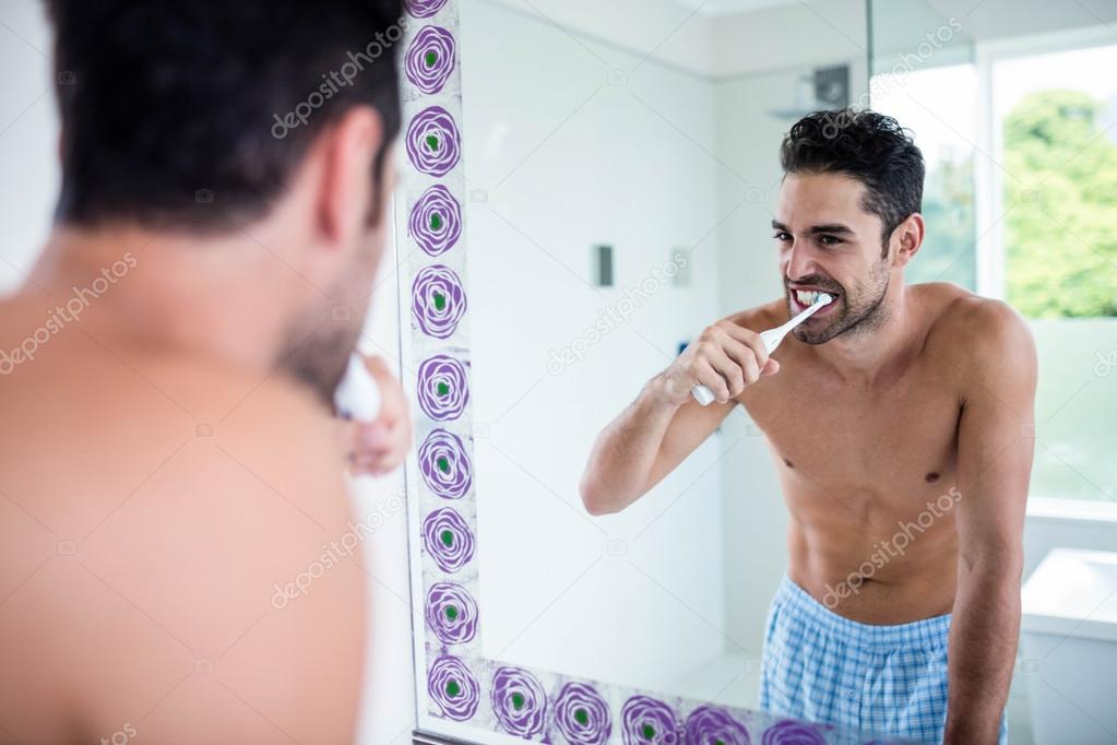 Handsome man brushing his teeth — Stock Photo © Wavebreakmedia #98066364