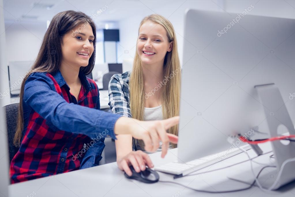 Smiling students using computer — Stock Photo © Wavebreakmedia #98083244