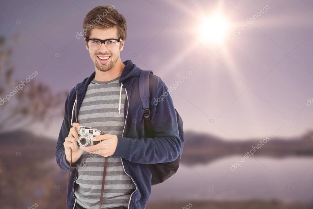 Happy man holding camera — Stock Photo © Wavebreakmedia #99883790