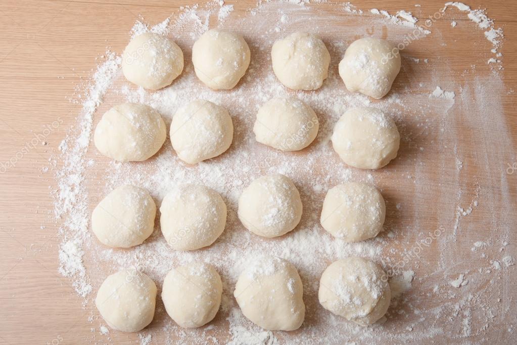 Small balls of dough with flour for pizza or cakes and scones. S ...