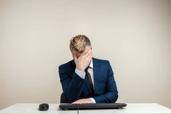 Man businessman tired at the computer, office worker in a tired state ...