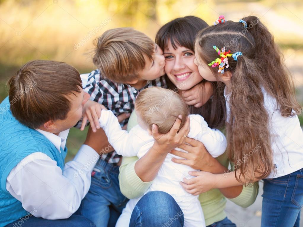 Large family hugging and having fun outdoors. — Stock Photo © Vitalinka ...