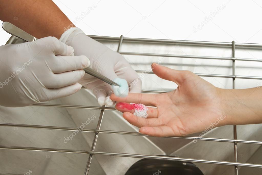 Medical assistant changes the dressing of a wound at the emergen Stock ...