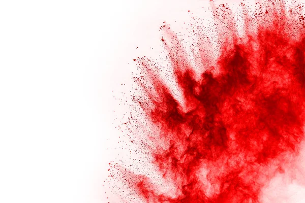 Freeze motion of red powder exploding, isolated on white background ...