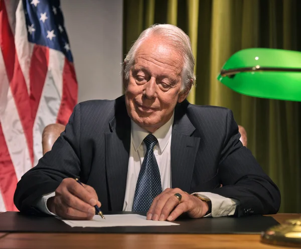 Big boss president writing behind desk with american flag in the Stock ...