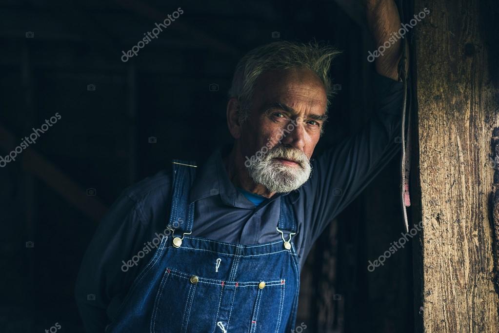 Elderly man staring through window Stock Photo by ©ysbrand 79823304