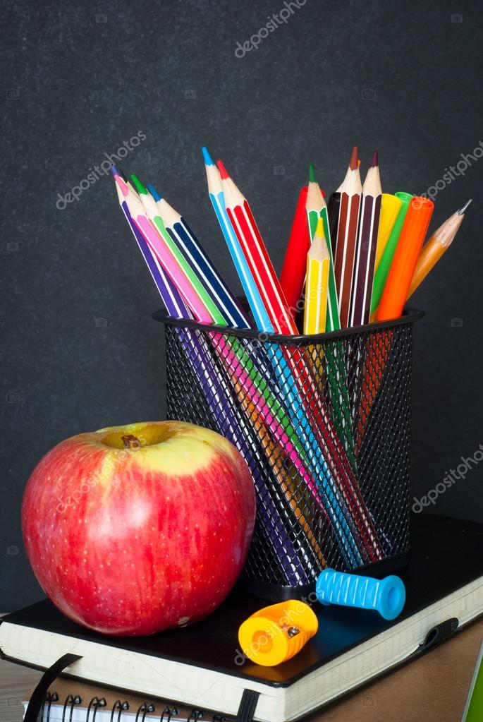 School supplies on classroom table Stock Photo by ©Nadianb 120760966