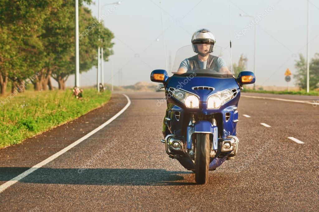 Man riding a motorcycle on an open road — Stock Photo © seenaad #83801954