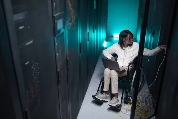 High angle portrait of disabled African-American woman using laptop ...