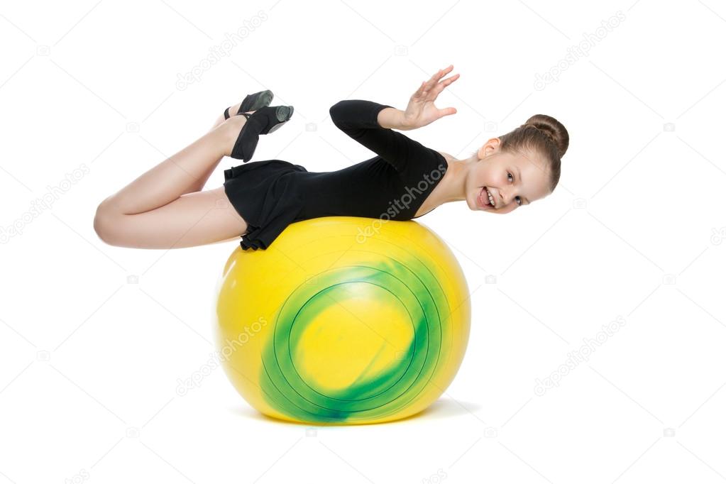 Girl does exercises on a big yellow balloon ⬇ Stock Photo, Image by ...