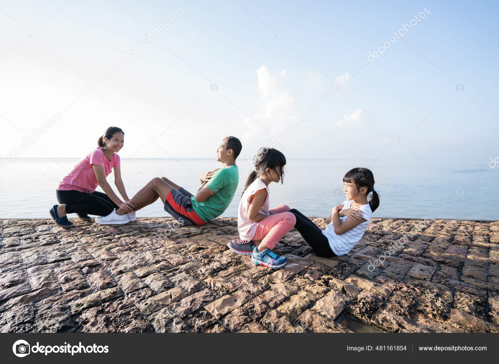 Asian parent and children do exercises outdoor — Stock Photo © odua ...