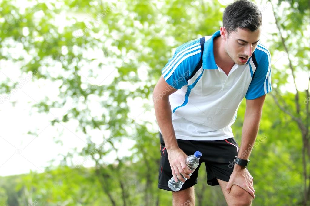 Sporty male runner taking a break after tired running — Stock Photo ...