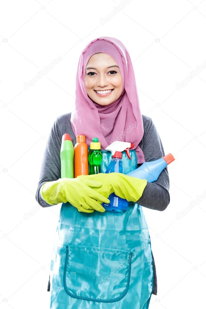 Young housewife carrying many bottles of cleaning fluid Stock Photo by ...
