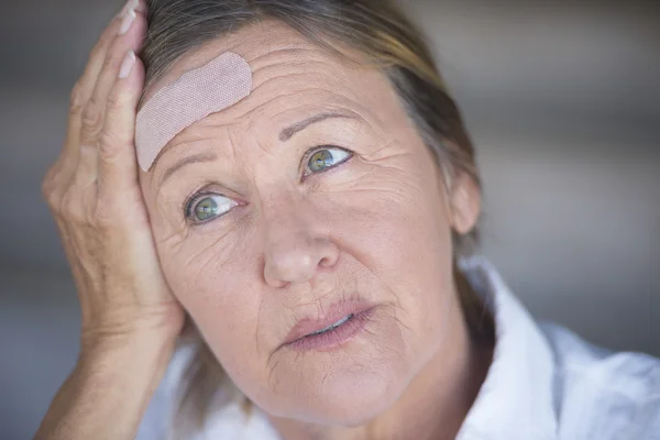 Woman with painful headache and band aid Stock Photo by ©roboriginal ...