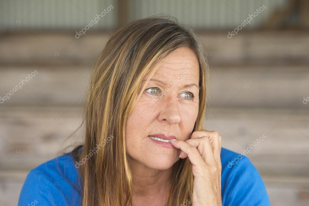 Shy woman biting insecure finger nails Stock Photo by ©roboriginal 71569707