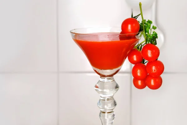 juicy bunch of red small cocktail tomatoes, tomato juice is poured into ...