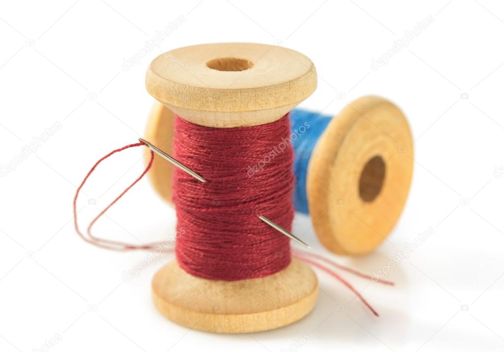 Spool of thread and needle on white Stock Photo by ©seregam 114207522