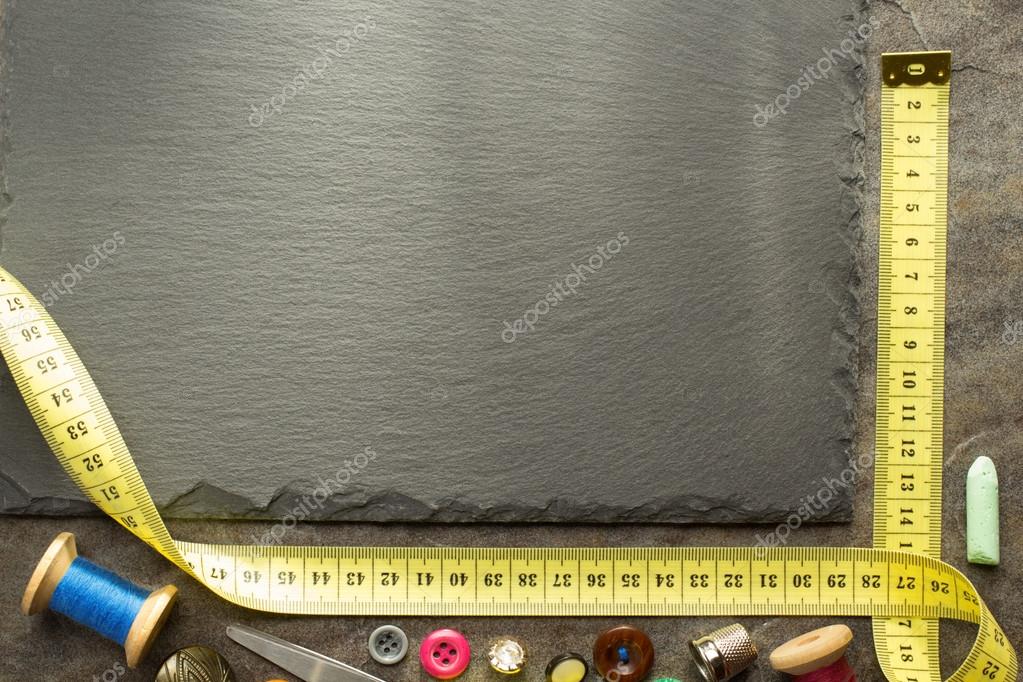 Sewing tools and measuring tape on table Stock Photo by ©seregam 115451026