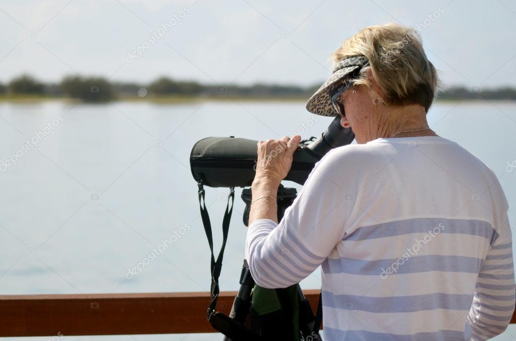 Mature woman birdwatching – Stock Editorial Photo © lucidwaters #55361267