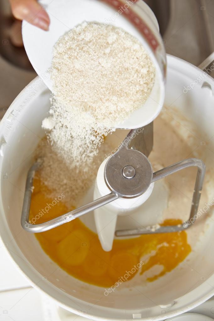 Adding ingredient to batter machine Stock Photo by ©OtnaYdur 74591287