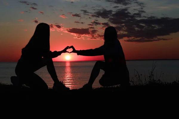 Two Best Friends Holding Hands In The Sunset
