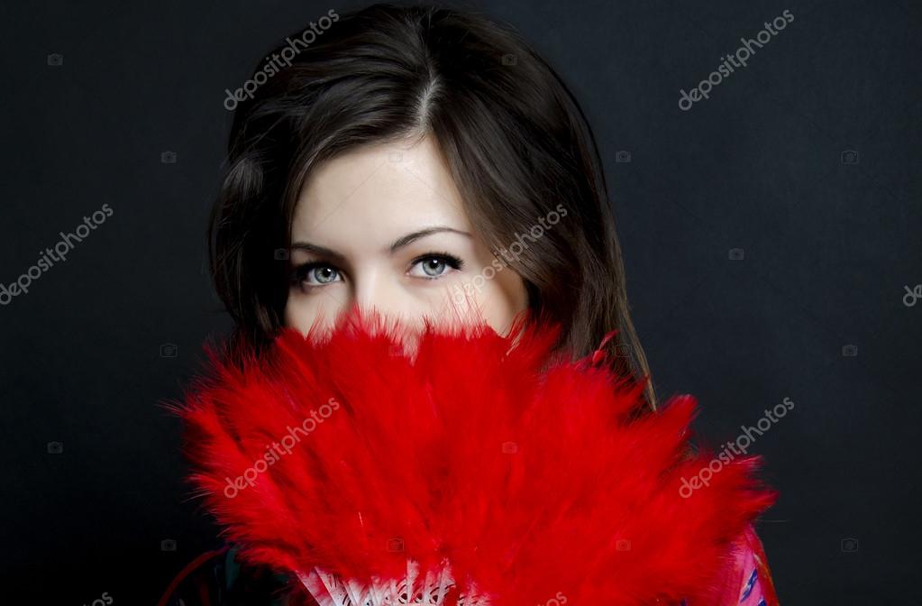 Woman's face covered with red fan on dark Stock Photo by ©Aqvamarine ...