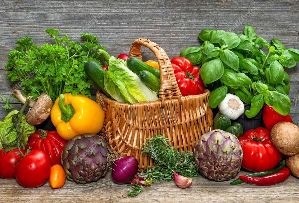 Vegetables and herbs on wooden background. Fresh food ingredient ...