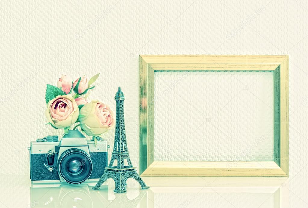 Golden picture frame, flowers and vintage camera. Nostalgic deco ...