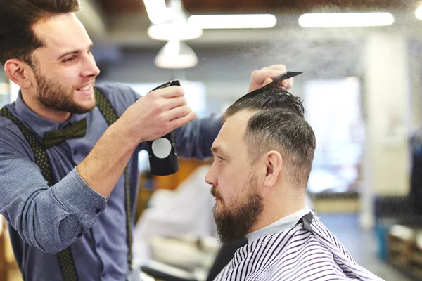Classic haircut in a barbershop. Curve hair styling and hair health ...