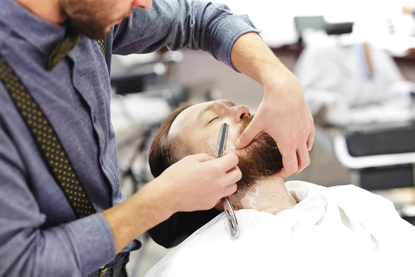 Barber shaving beard Stock Photo by ©pressmaster 104861522 Barber shaving beard Stock Photo by ©pressmaster 104861522