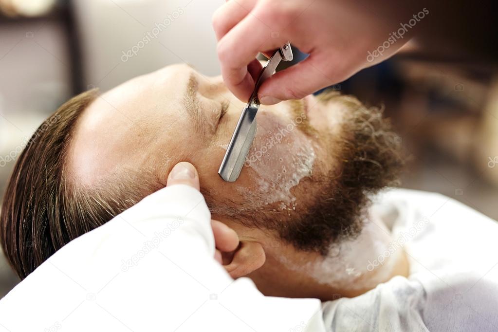 Barber shaving beard Stock Photo by ©pressmaster 104861522 Barber shaving beard Stock Photo by ©pressmaster 104861522