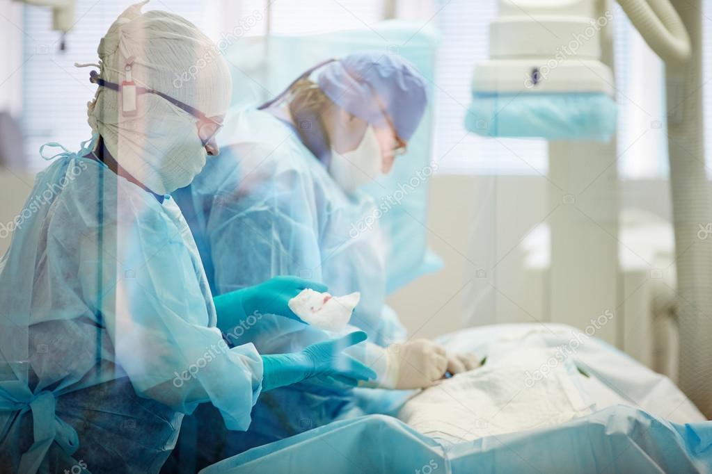 Surgeon performing operation Stock Photo by ©pressmaster 112554338