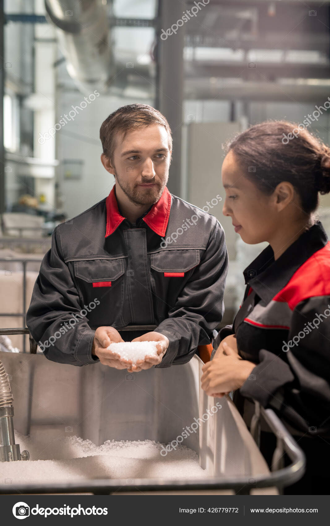 Two Young Quality Control Managers Workwear Discussing Characteristics ...