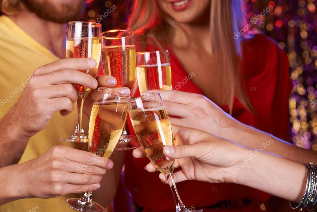 Hands cheering up with champagne — Stock Photo © pressmaster #53811151