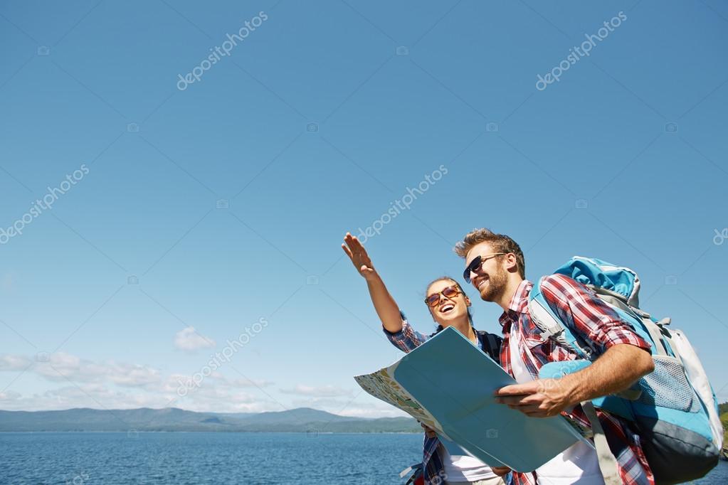 Hikers with map choosing route — Stock Photo © pressmaster #83027876