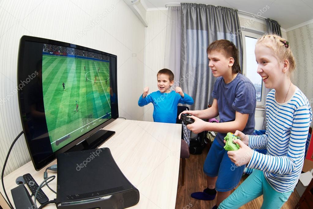 Children playing on games console to play football — Stock Photo ...