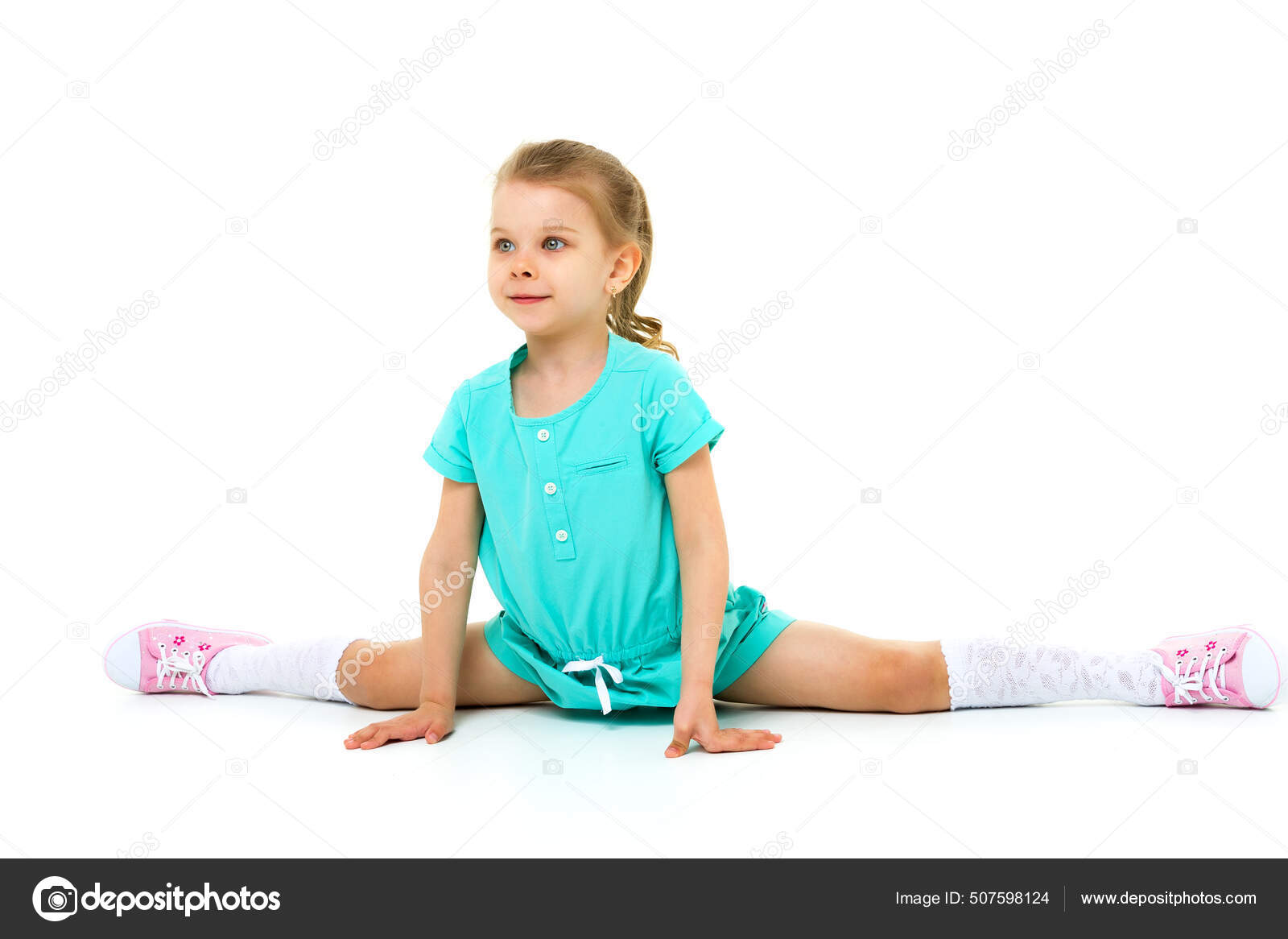 Adorable active little girl doing split on floor Stock Photo by ...