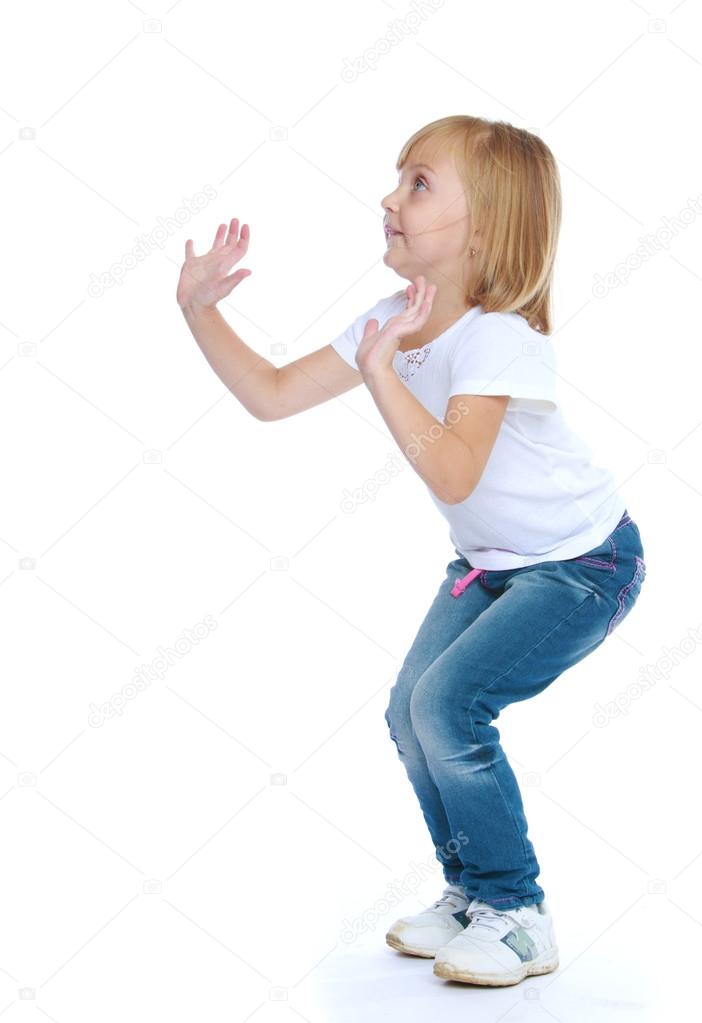 Little girl jumping hands up. Stock Photo by ©lotosfoto1 64704773