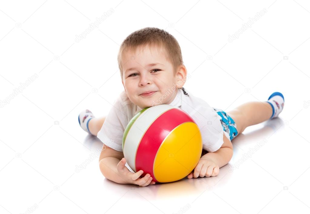 Beautiful little boy lying on the floor hugging striped ball — Stock ...