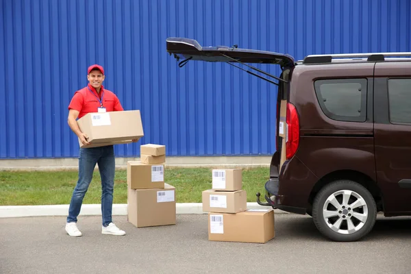 Courier Loading Packages Car Trunk Outdoors Stock Photo by ©NewAfrica ...