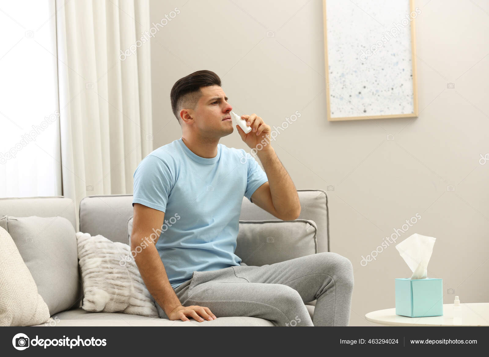 Ill Man Using Nasal Spray Sofa Home — Stock Photo © NewAfrica #463294024
