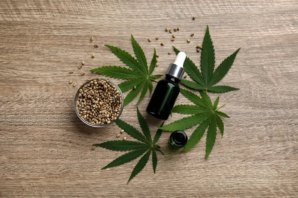 Flat lay composition with hemp leaves, CBD oil and THC tincture on ...