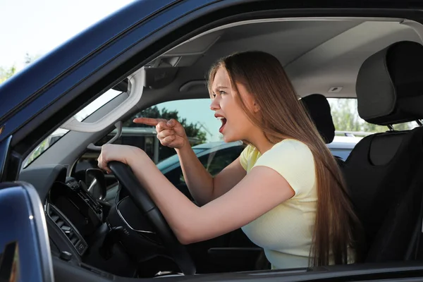 Emotional woman in car. Aggressive driving behavior - Stock Image ...