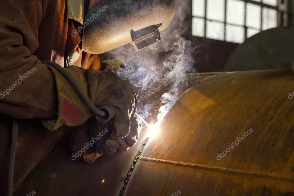 Welder performs welding large diameter pipe — Stock Photo © shinobi ...