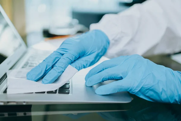 Scientists are cleaning labtop by alcohol and tissue after checking and ...